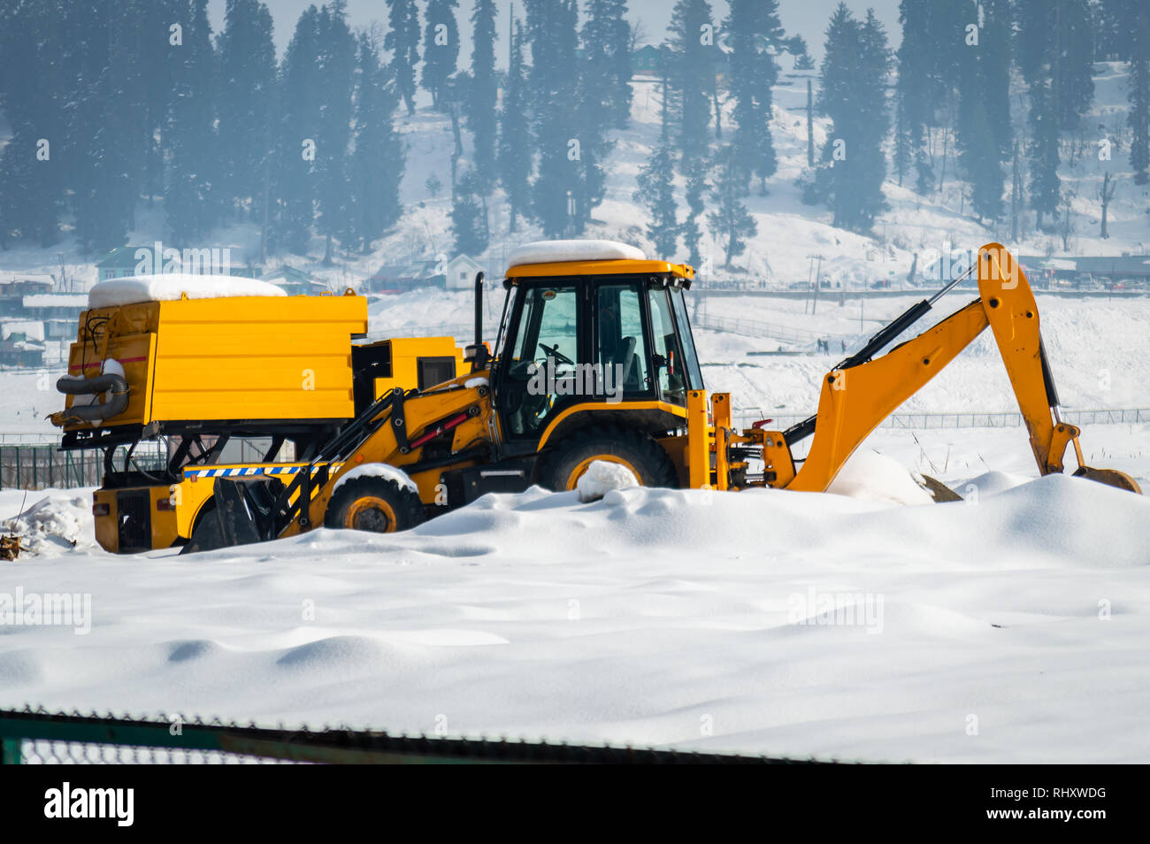 A bulldozer, crane, snow machine ready for clearing snow off the roads ...