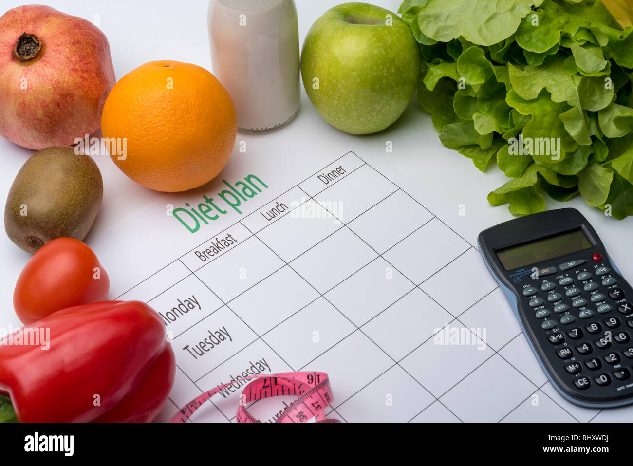 Diet plan sheet and fresh food on white background. Top view, the ...