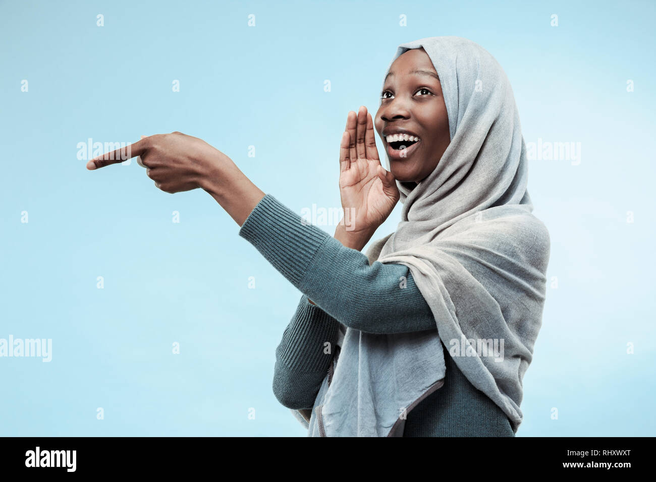 Secret, gossip concept. Young african woman whispering a secret behind ...