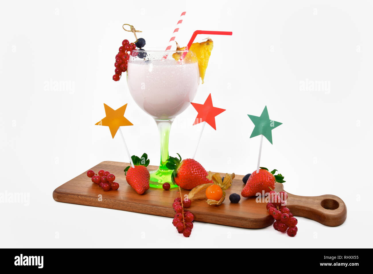 Strawberry milkshake in a glass of balloon with fruits on a white ...