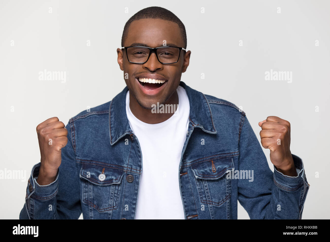 Excited african american man feeling winner triumphant looking at ...