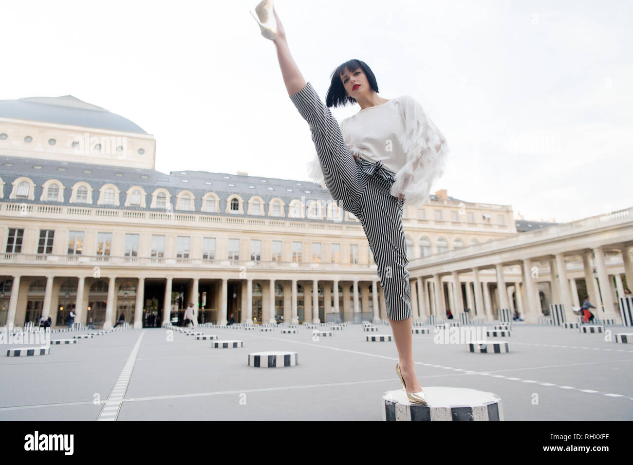 Young stylish woman in pants with split on street in Paris, France ...