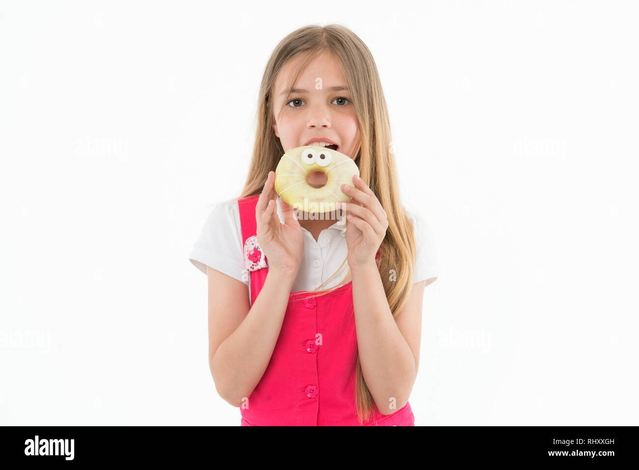 Little girl eat donut isolated on white. Child with glazed ring ...