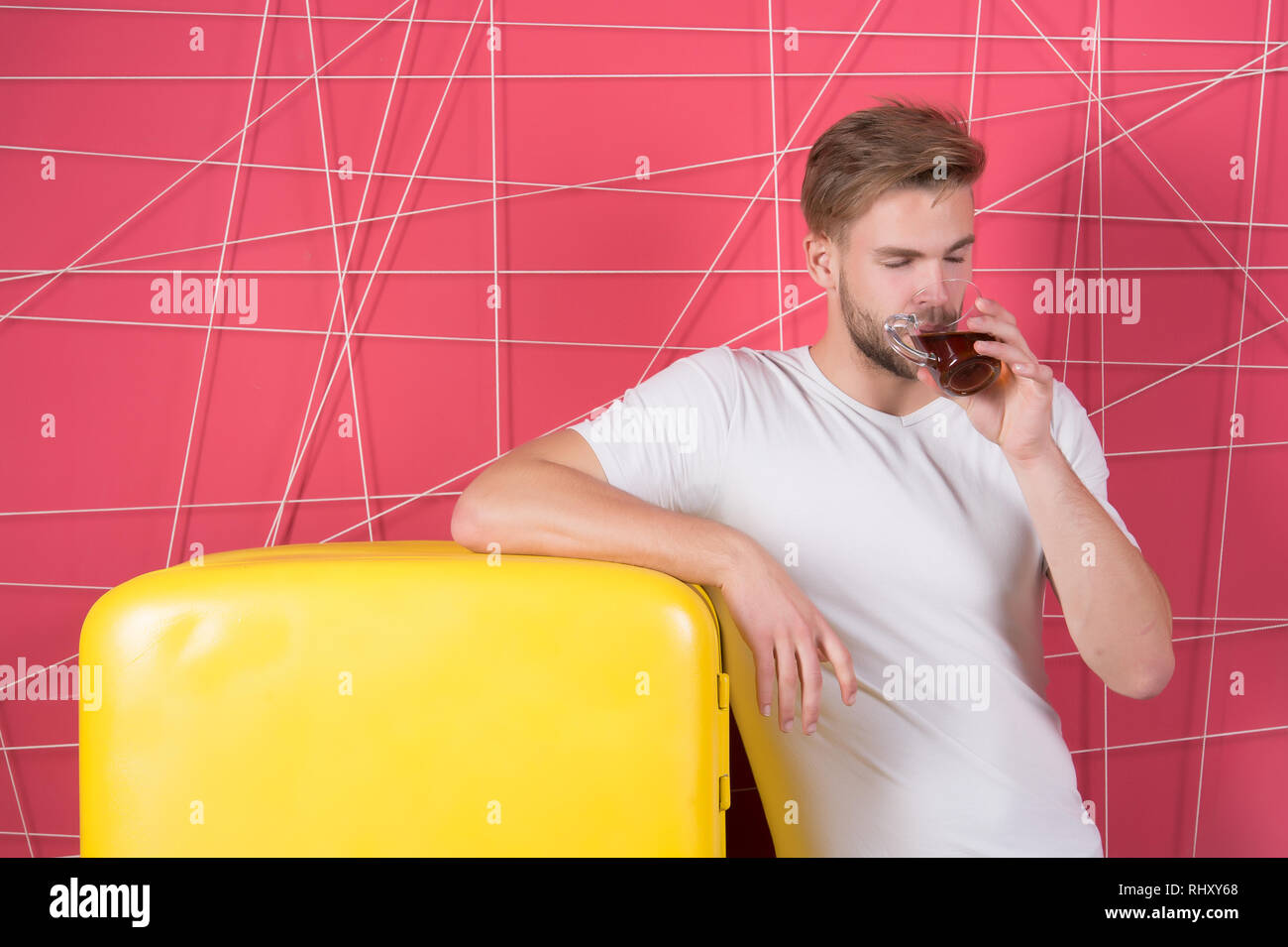 Morning concept with macho drink tea or coffee at fridge in kitchen ...