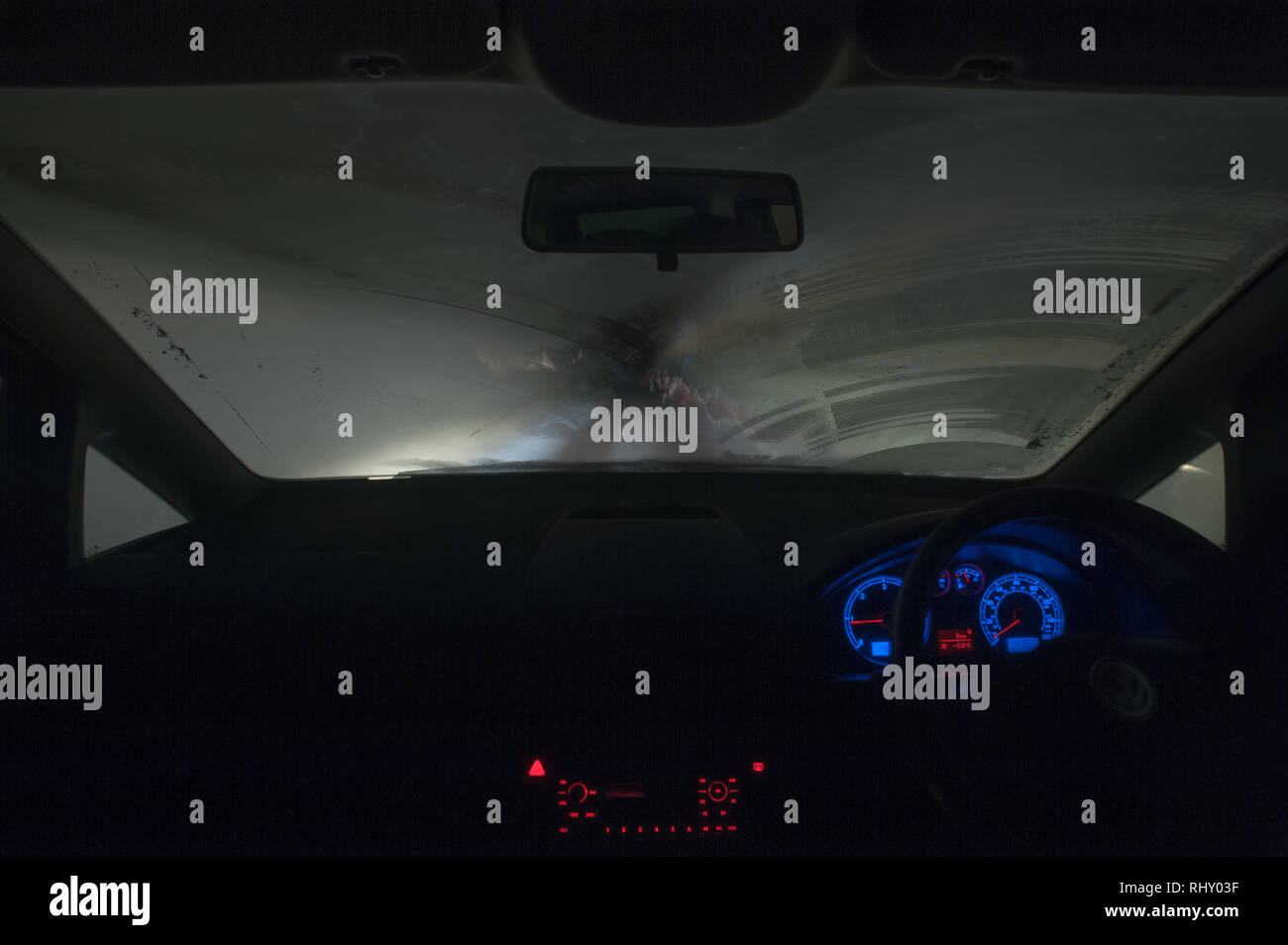 Misty and foggy conditions at night with snow flurry in British winter ...