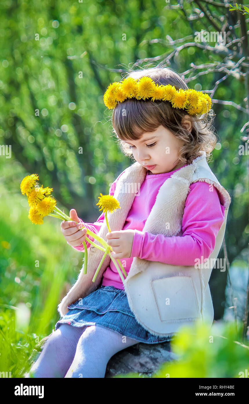 Girl, child, flowers in the spring plays. Selective focus Stock Photo ...