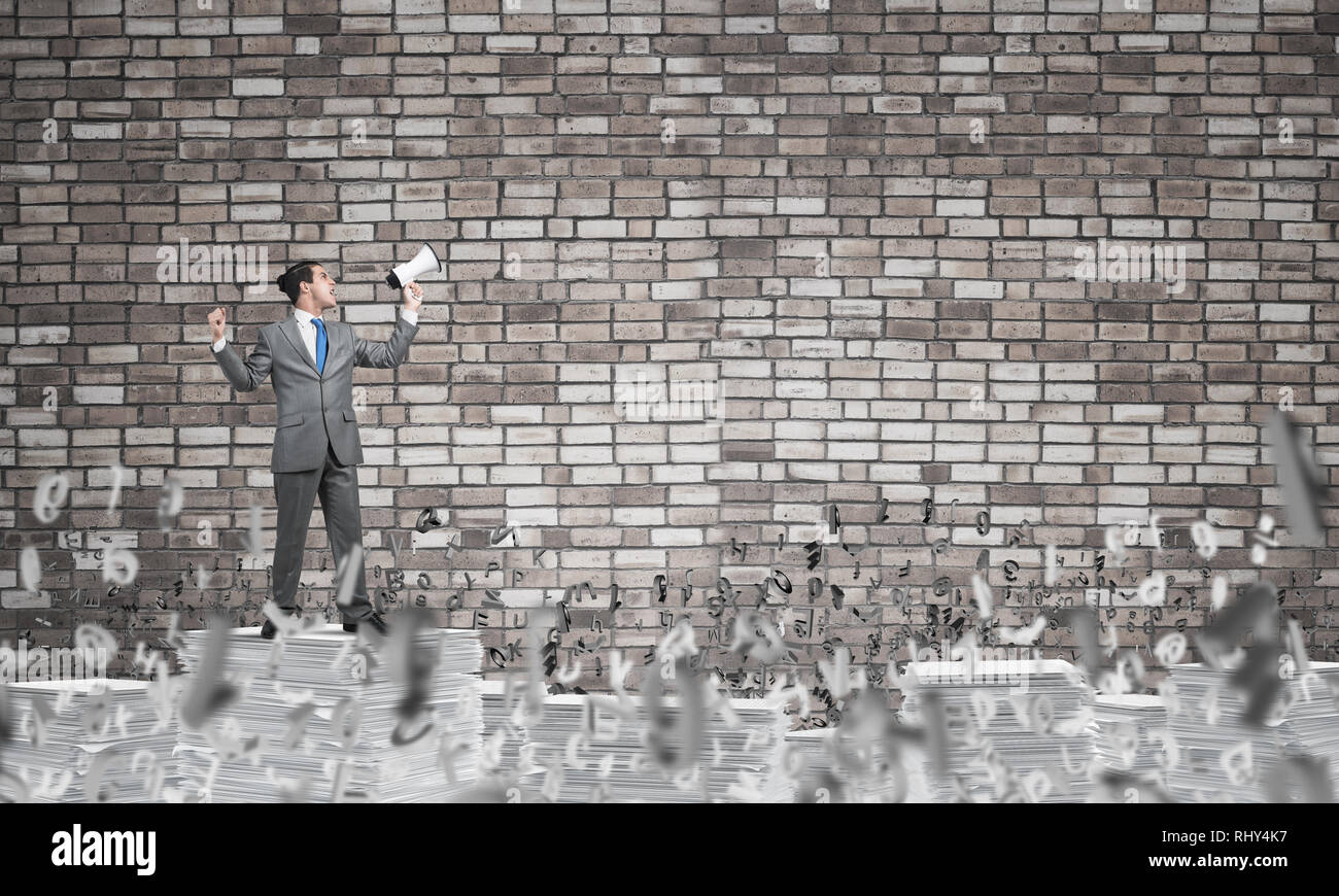 Businessman standing with megaphone Stock Photo - Alamy