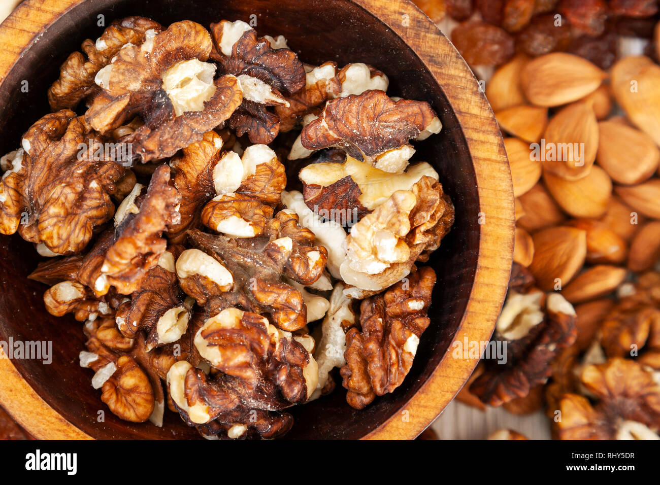 Peeled walnut in a wooden cedar plate on the background a scattering of ...