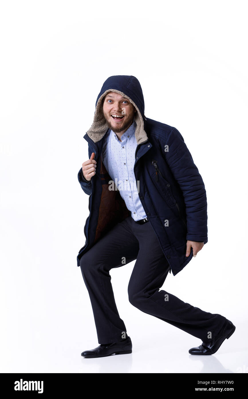 Smiling young guy in winter warm coat. Fashionable man wearing blue ...