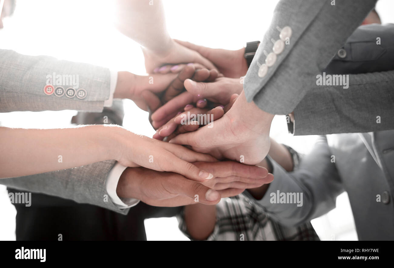 Closeup of a business colleagues with their hands stacked together ...