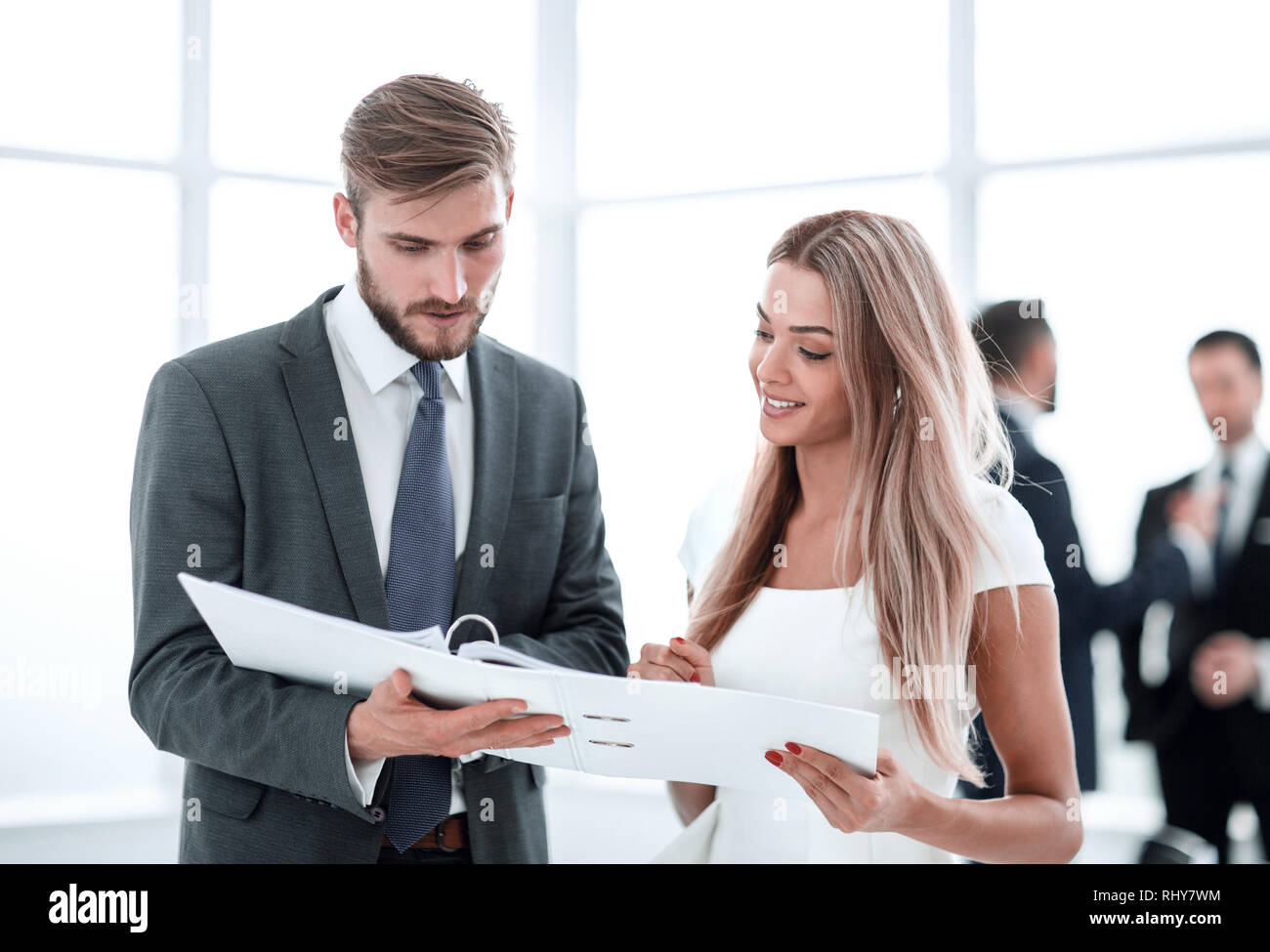 Manager discussing with the client the business document Stock Photo ...