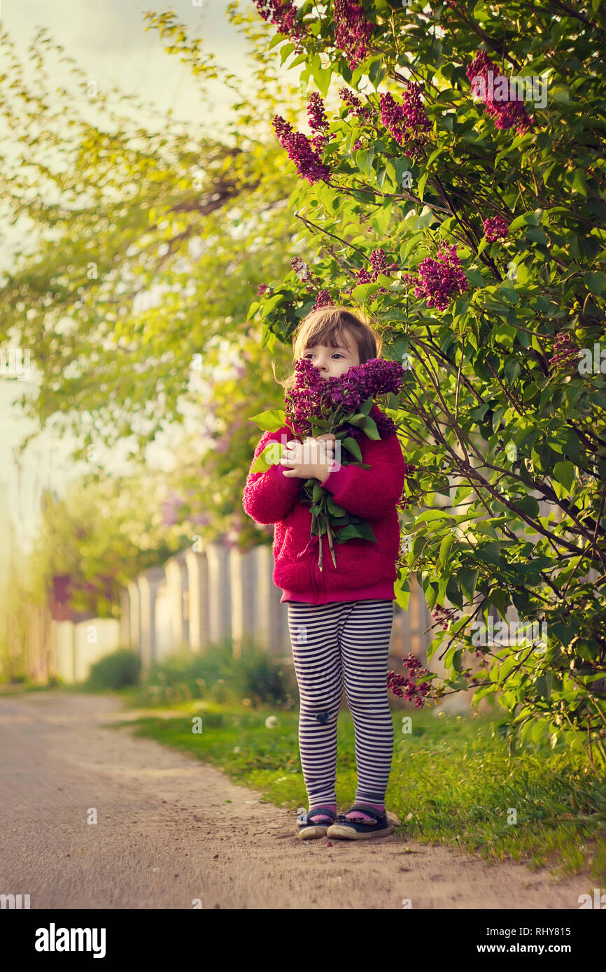 Girl with flowers in the spring outside. Selective focus Stock Photo ...