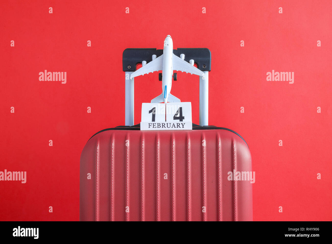 Suitcase with 14 of february wooden calendar and airplane model toy on ...