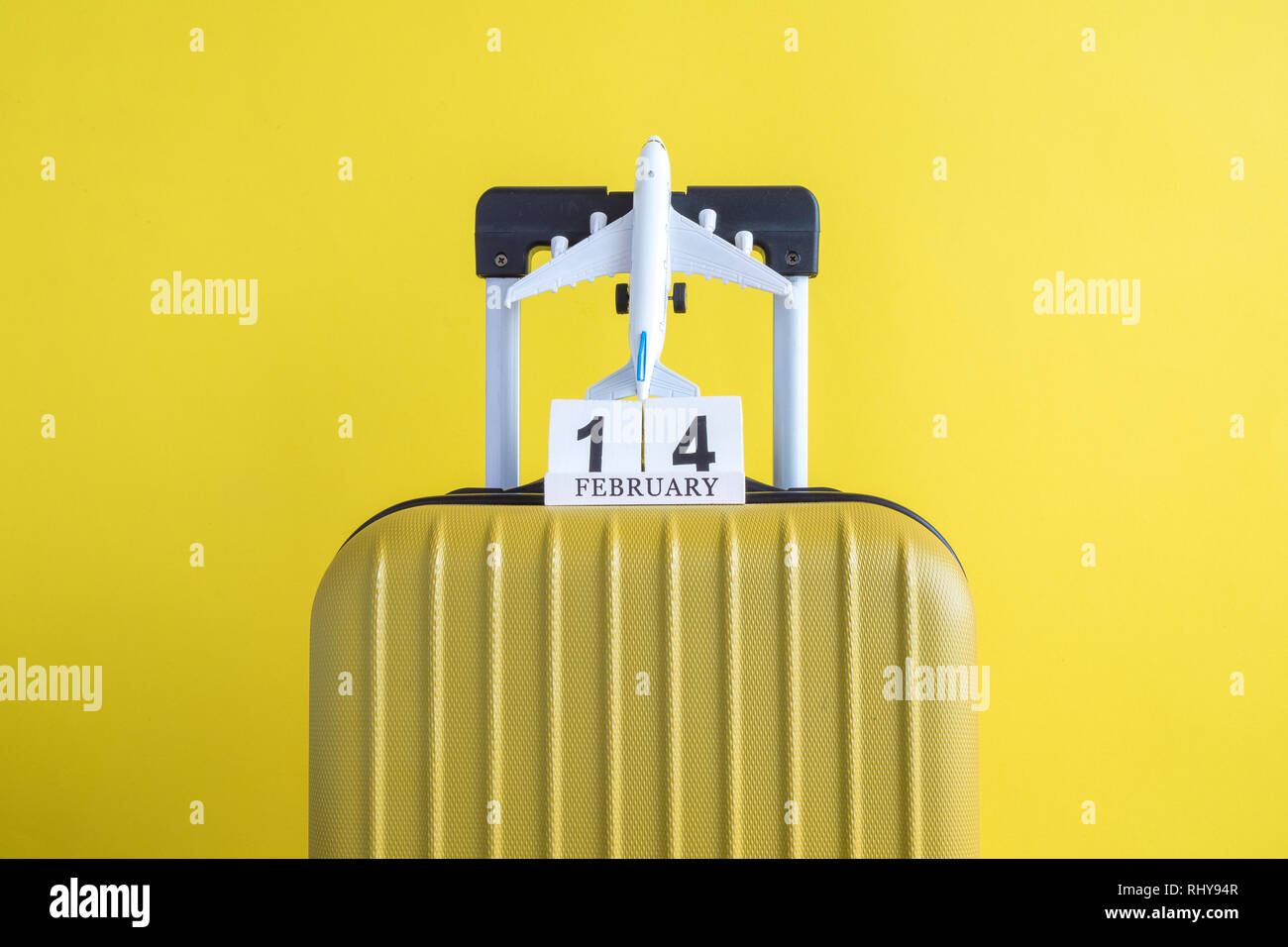 Suitcase with 14 of february wooden calendar and airplane model toy on ...