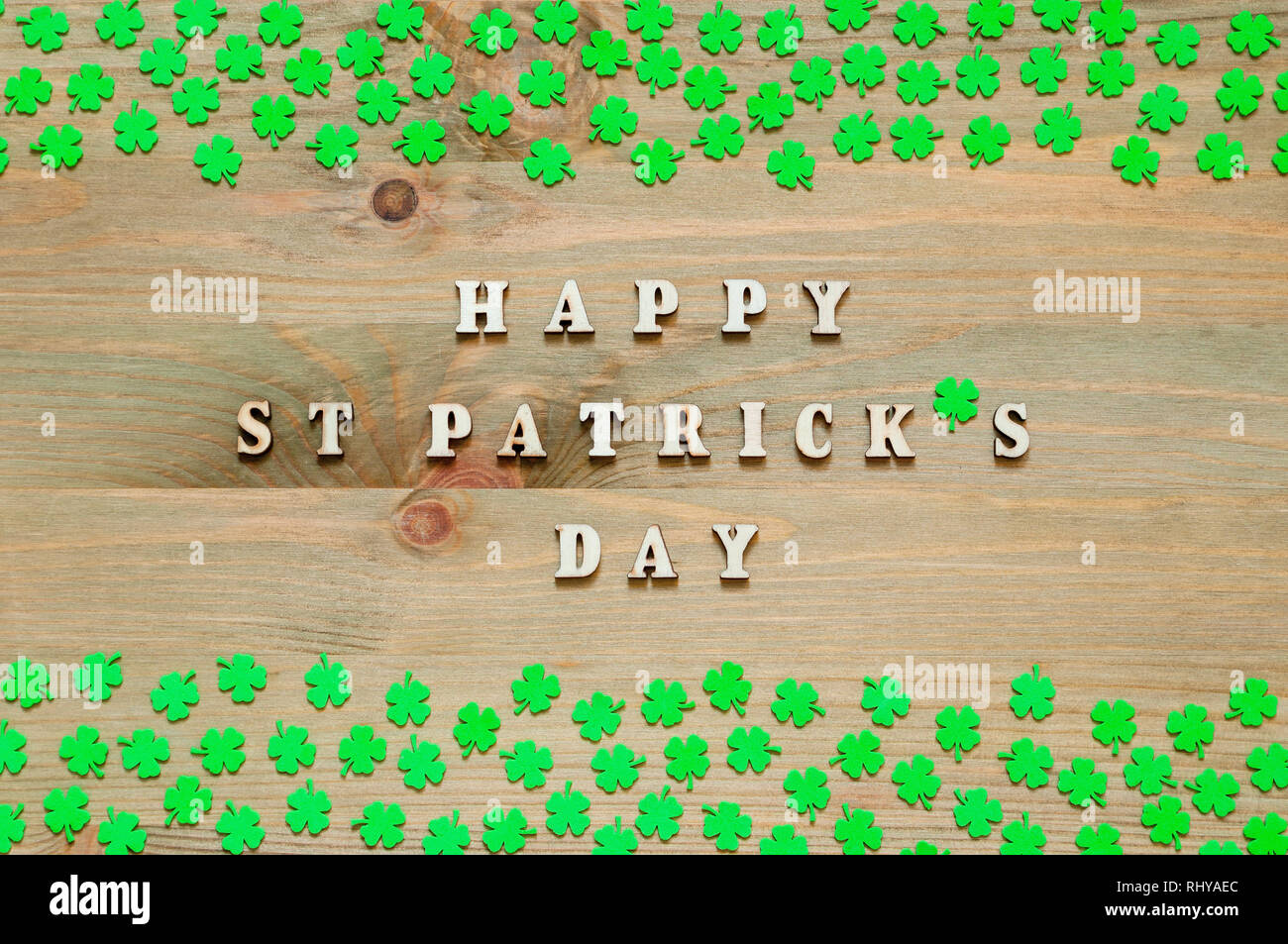 St Patrick's Day background. Green quatrefoils on the wooden background ...