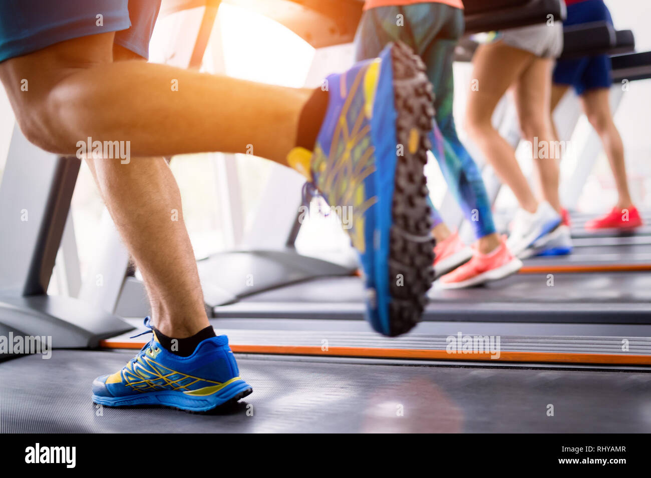 Healthy man and woman running on a treadmill in a gym Stock Photo - Alamy