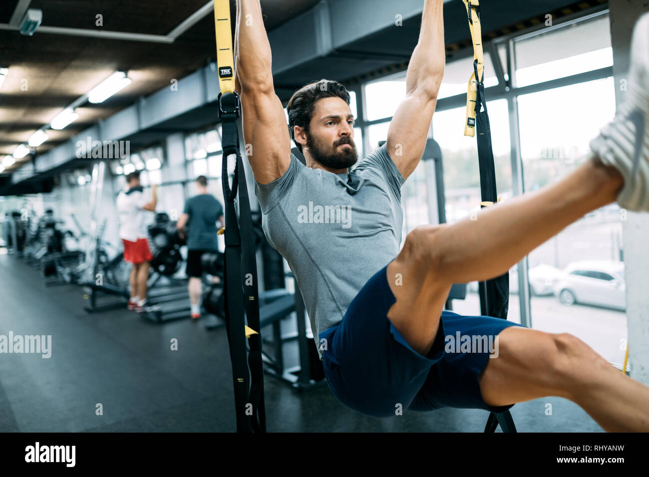 Caucasian man exercising with suspension training trx Stock Photo - Alamy