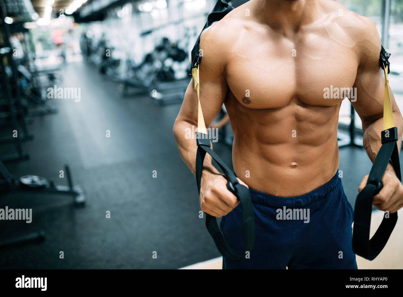 Young handsome man doing exercises in gym Stock Photo - Alamy