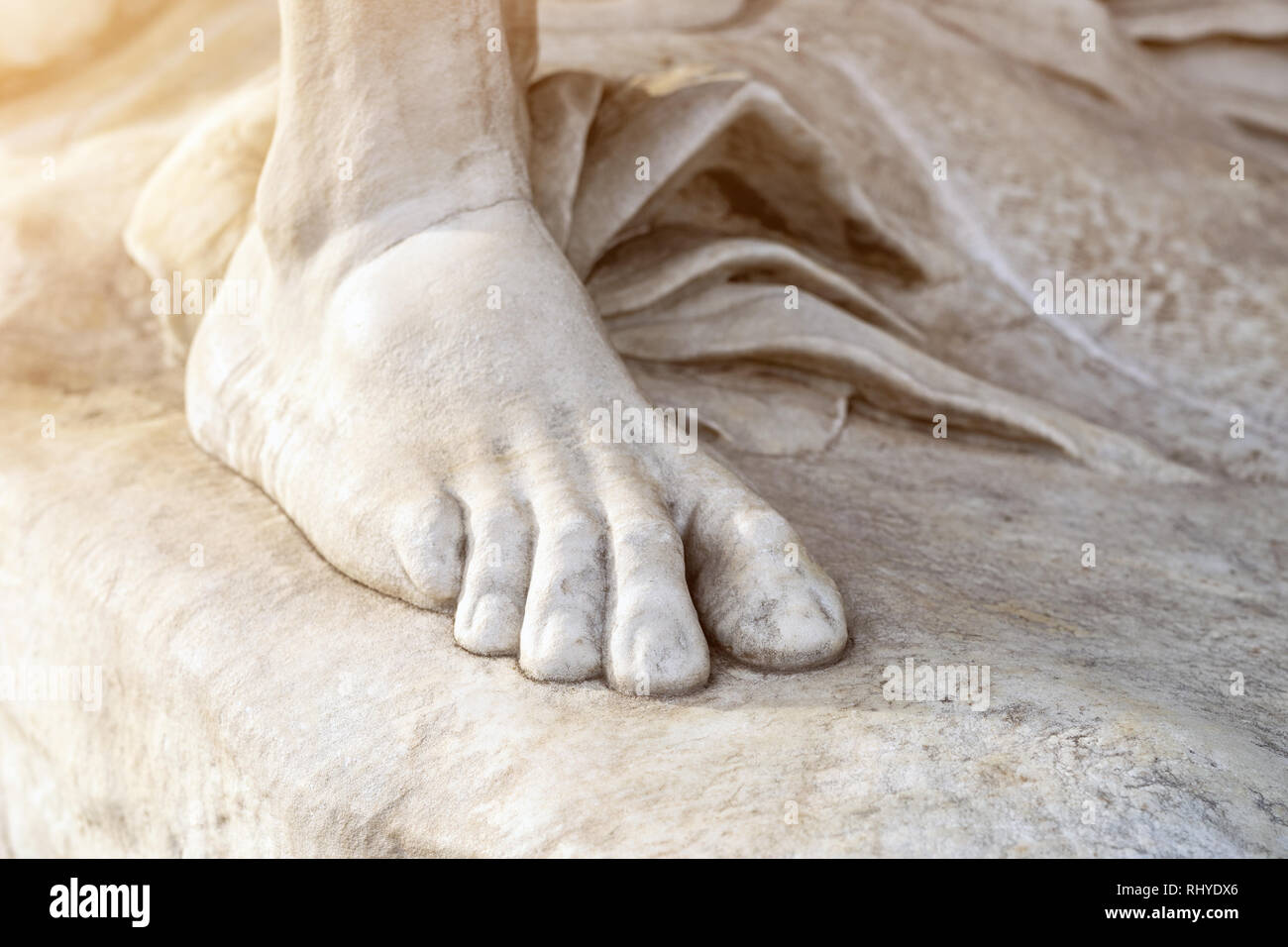 Part of leg of ancient marble statue. Close-up stone foot. Pedicure and ...