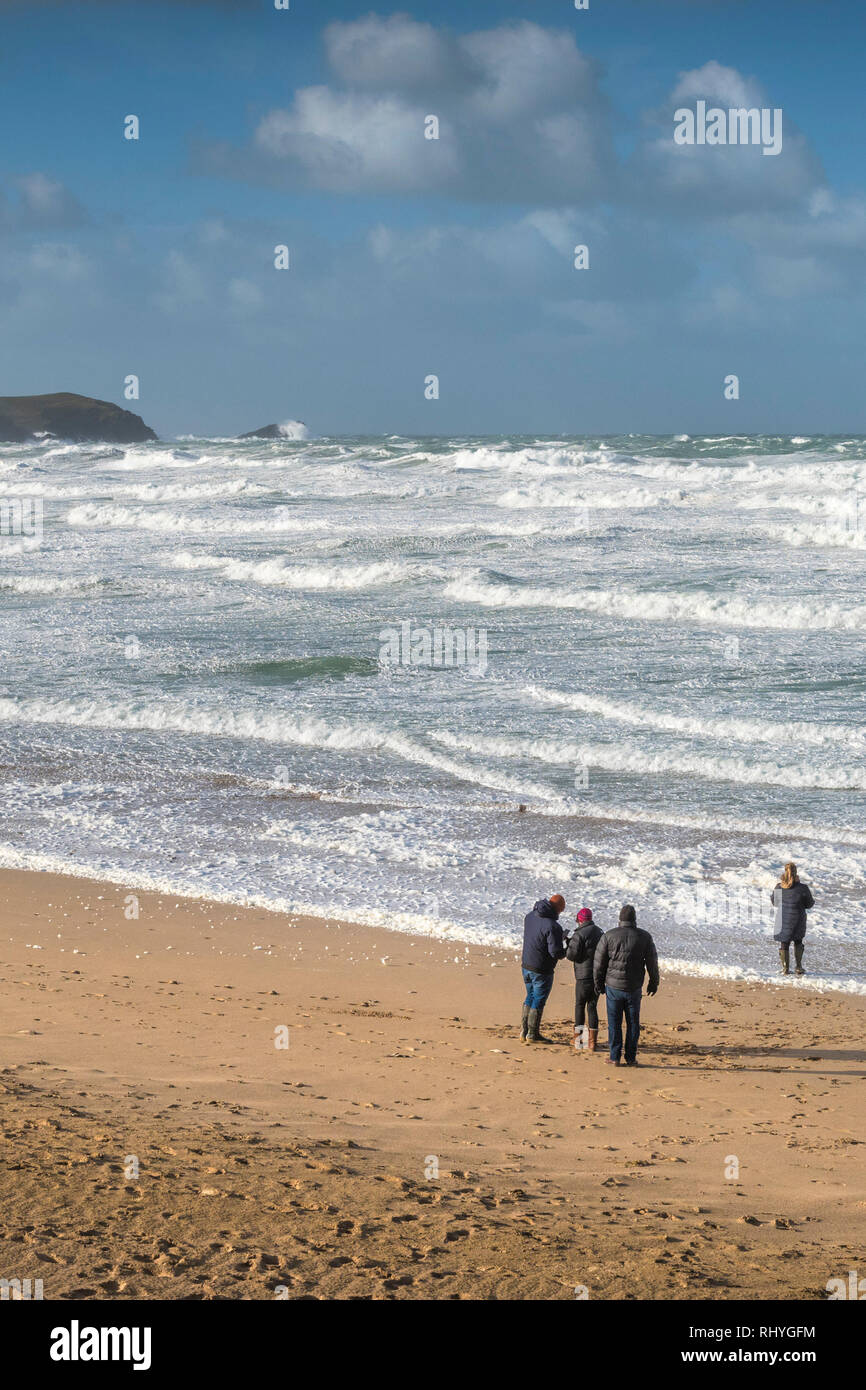 People standing on the beach and enjoying the wild weather conditions ...