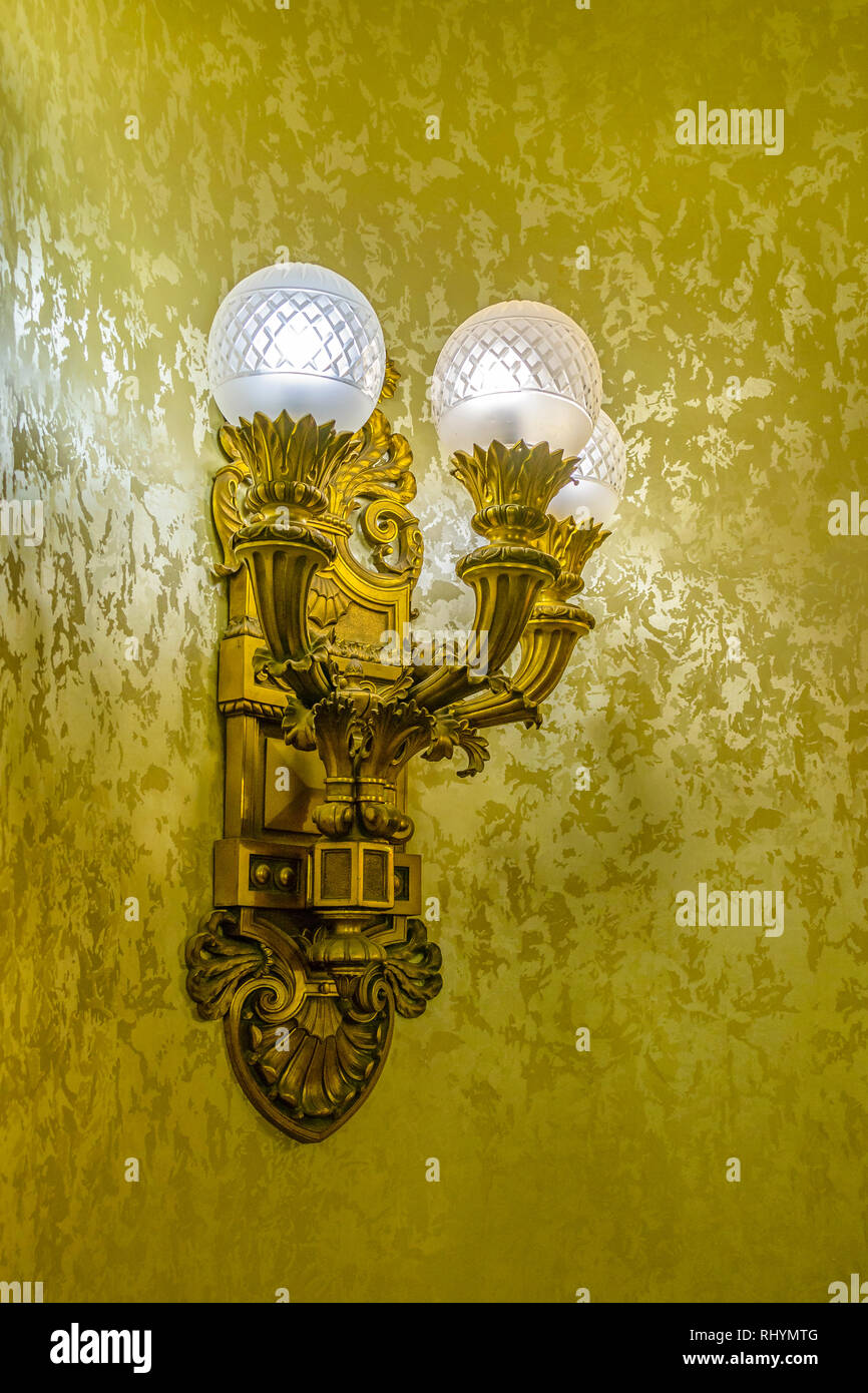 Elegant ornamented old style wall lamp over patterned wall Stock Photo ...