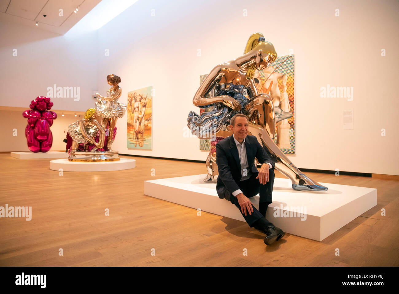 Artist Jeff Koons poses next to his piece called Seated Ballerina ...
