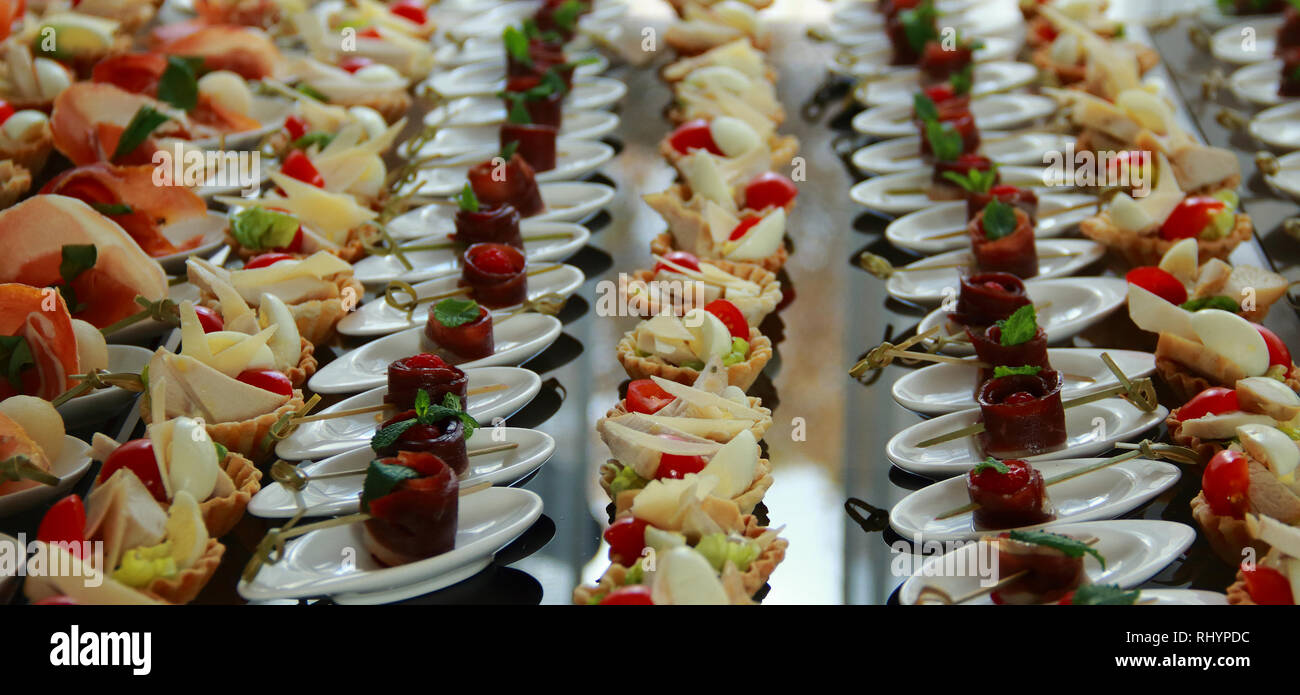 Side view of variety starters and appetizers setting for food reception ...