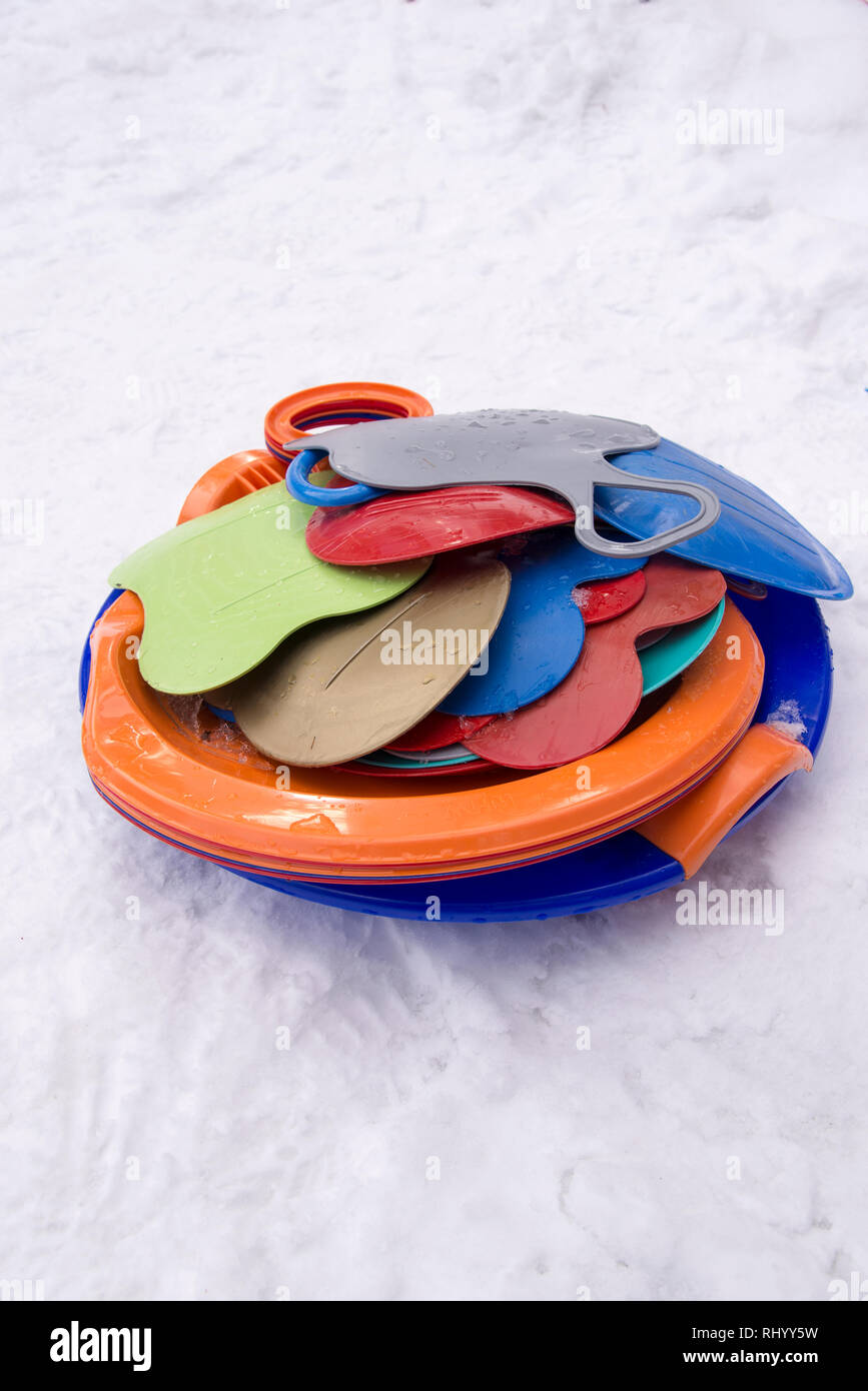 Colorful sleds for kids for sledding Stock Photo - Alamy