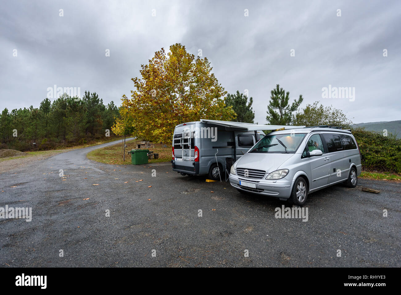 Campervan and motorhome camping on rainy day in nature parking. Family ...
