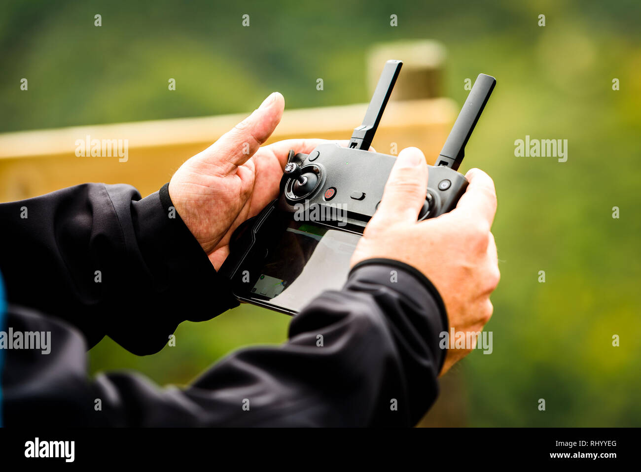 Hand holding drone quadcopter UAV remote control console controls ...