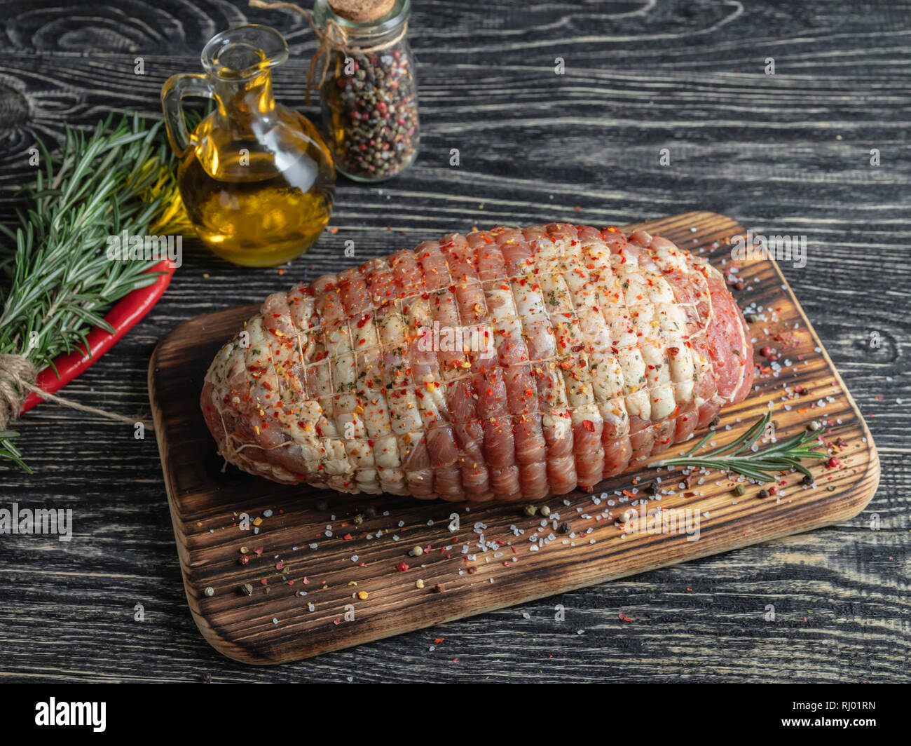 Raw pork roulade. Raw rolled meat enclosed in tied netting. Meat pulp ...