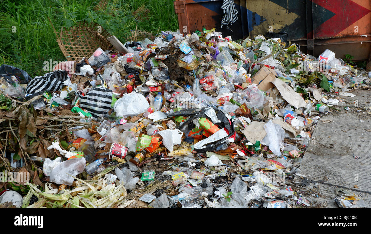 a pile of garbage on the roadside Stock Photo - Alamy