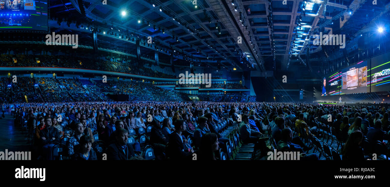 People attend business conference in congress hall at Synergy Global ...