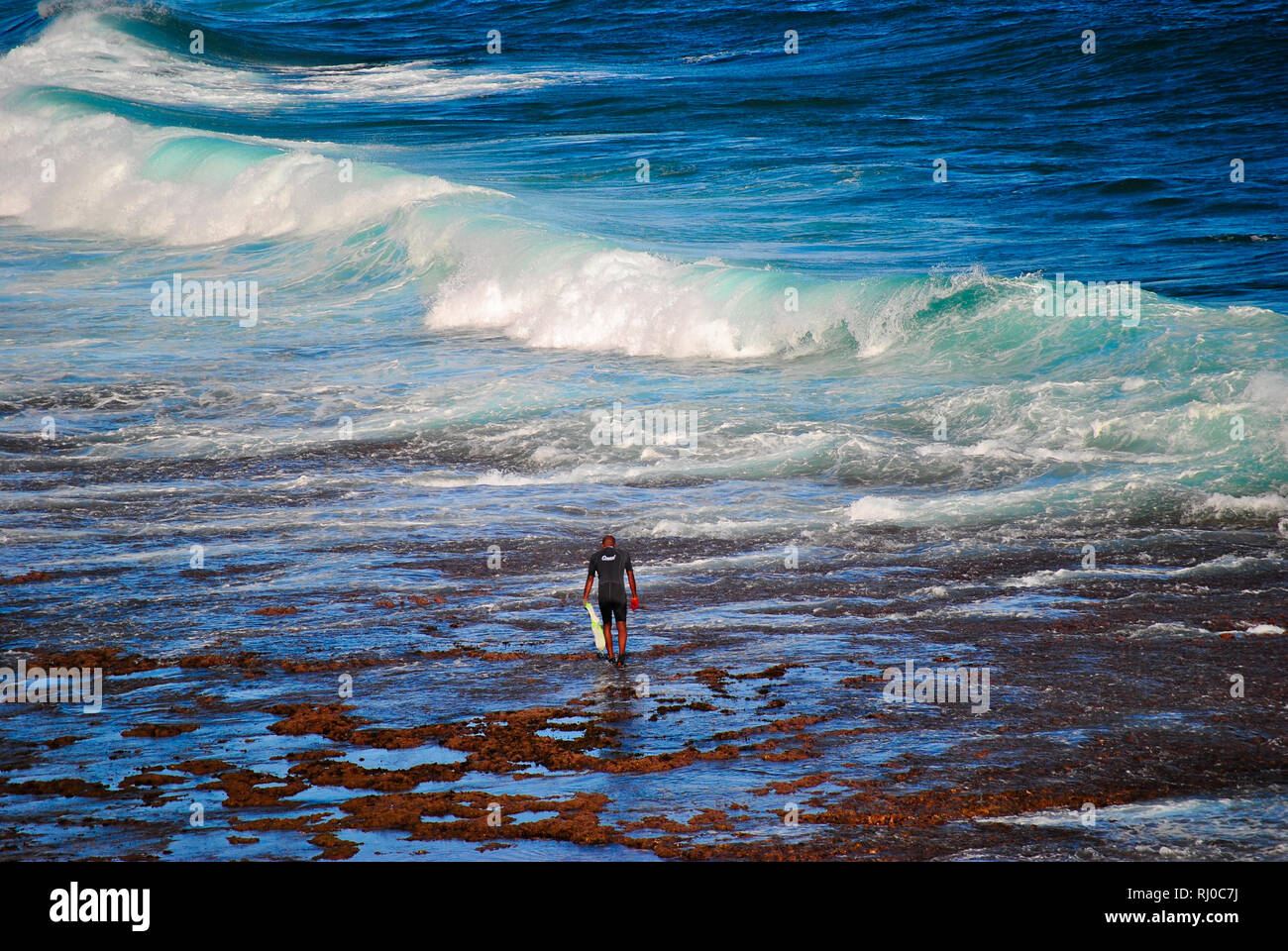 Man facing sea ocean waves Stock Photo - Alamy