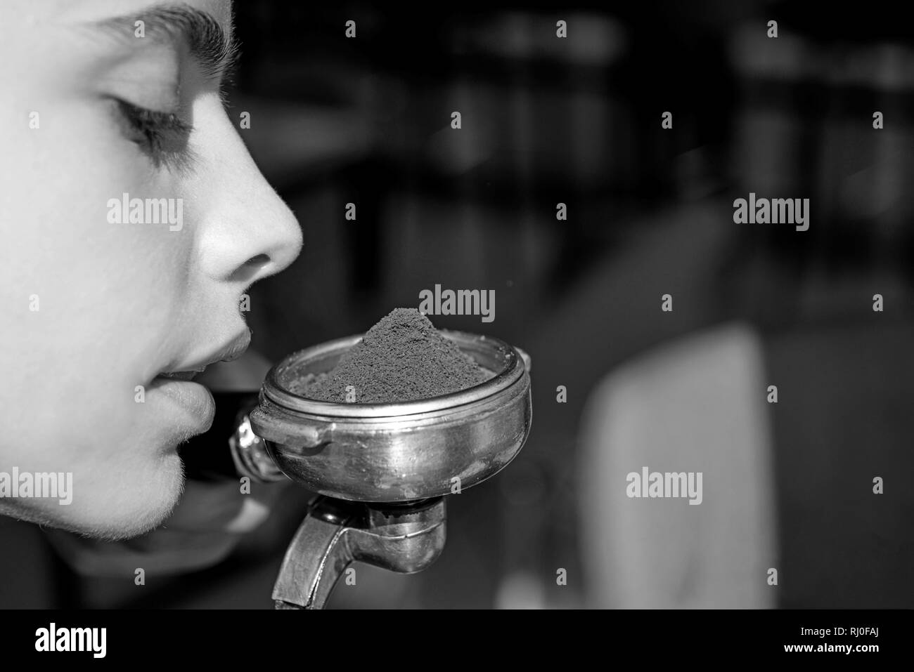 The best smell in the whole wide world. Woman barista hold portafilter ...