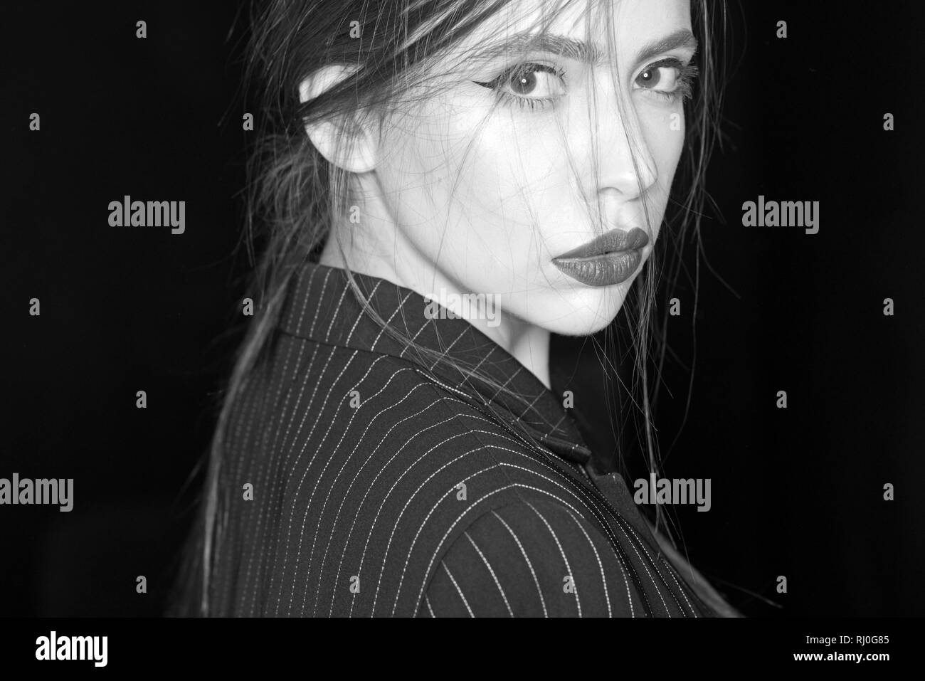 Femininity concept. Girl on strict confident face in black jacket ...