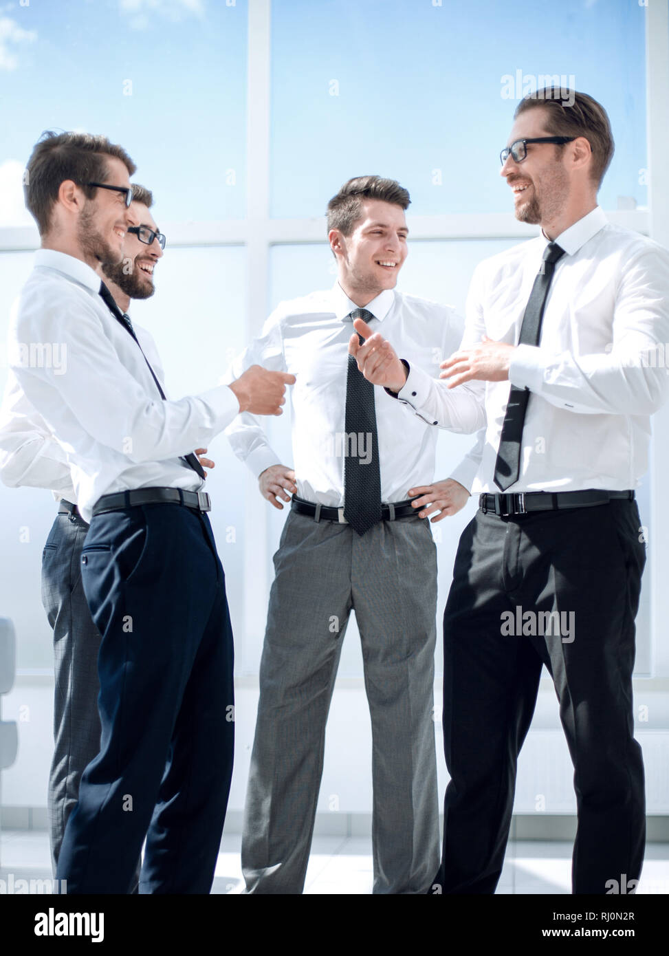 employees talking standing with the office lobby Stock Photo - Alamy