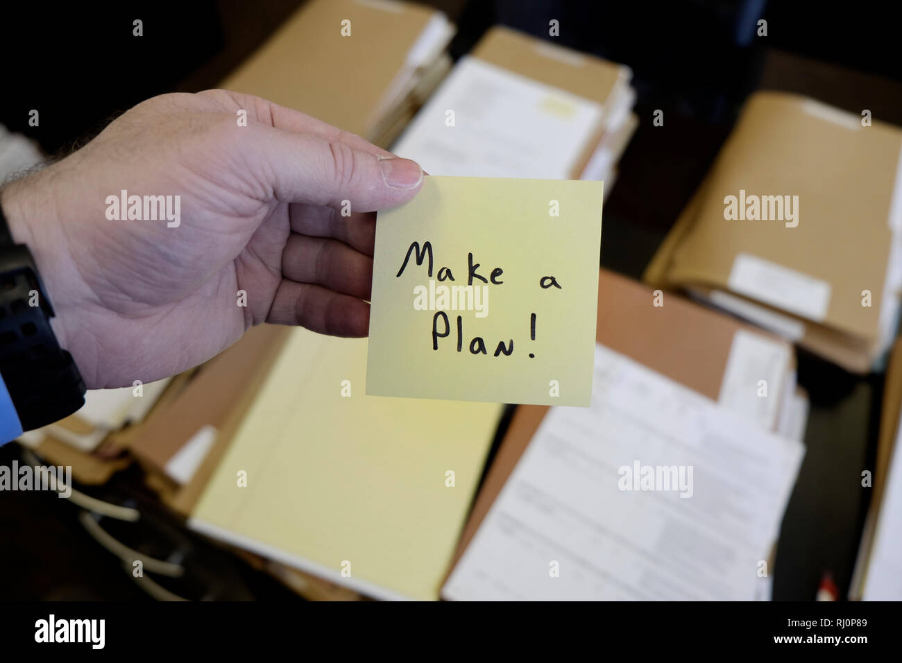 Sticky Note in Hand Businessman Desk Files Folder Working Message ...