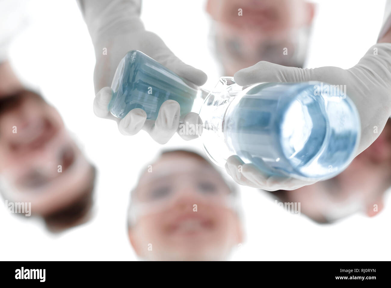 image is blurred. beakers in hand, and scientists Stock Photo - Alamy