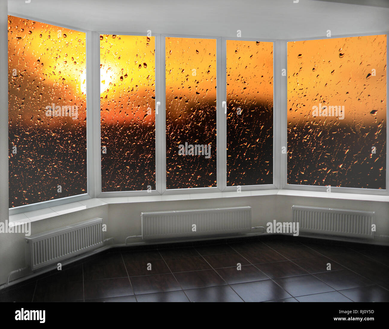 Plastic windows overlooking beautiful golden sunset. View from home ...