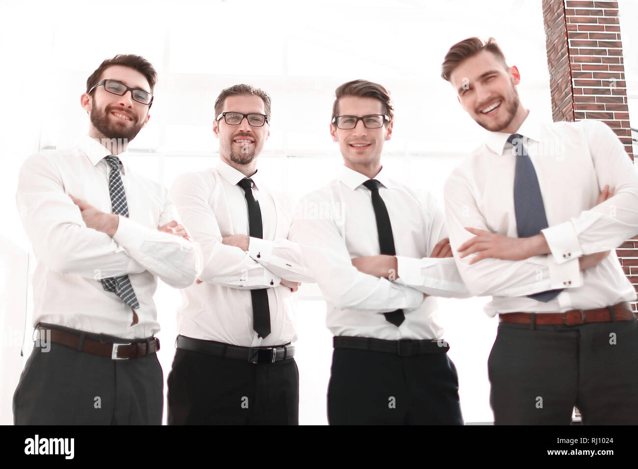 group of employees standing in a bright office Stock Photo - Alamy