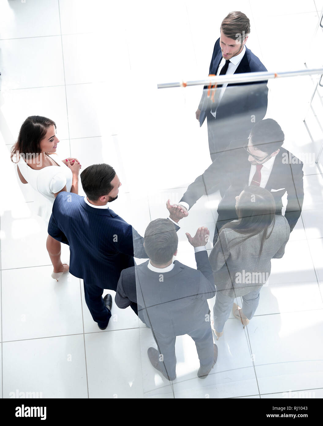 top view. business partners stretching out their hands for a handshake ...
