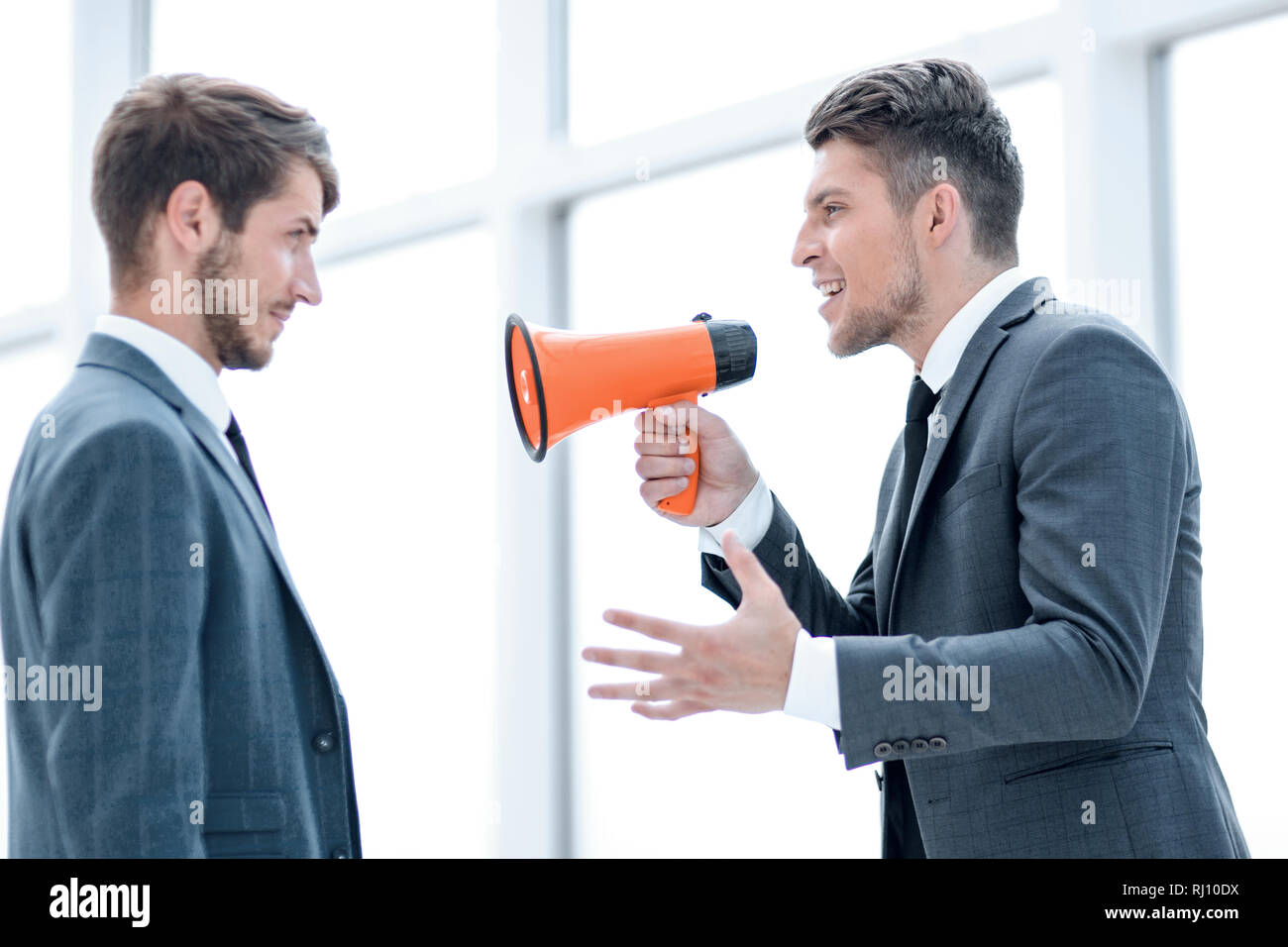 Man shouting colleague megaphone hi-res stock photography and images ...