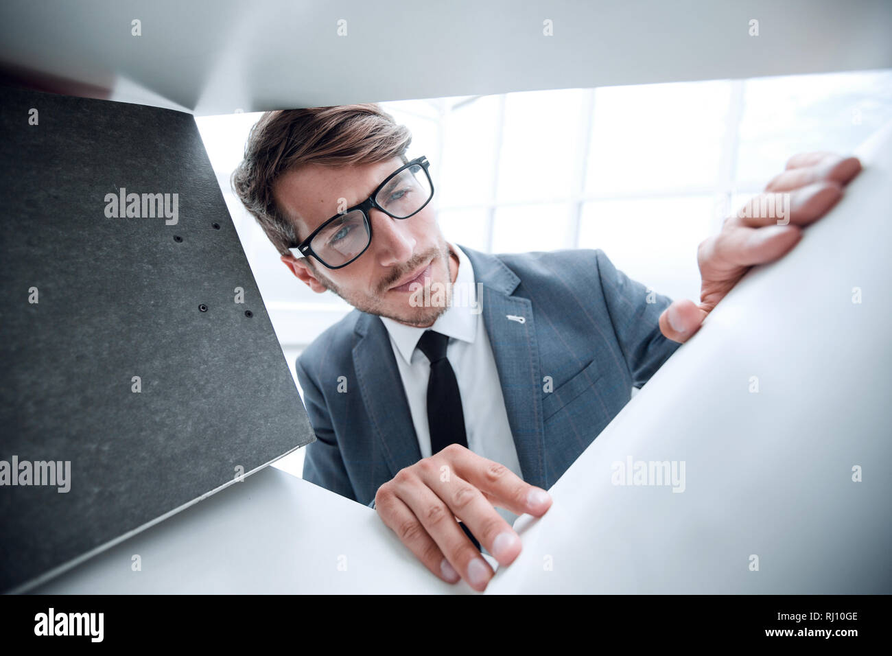 young businessman selects a folder for documents Stock Photo - Alamy