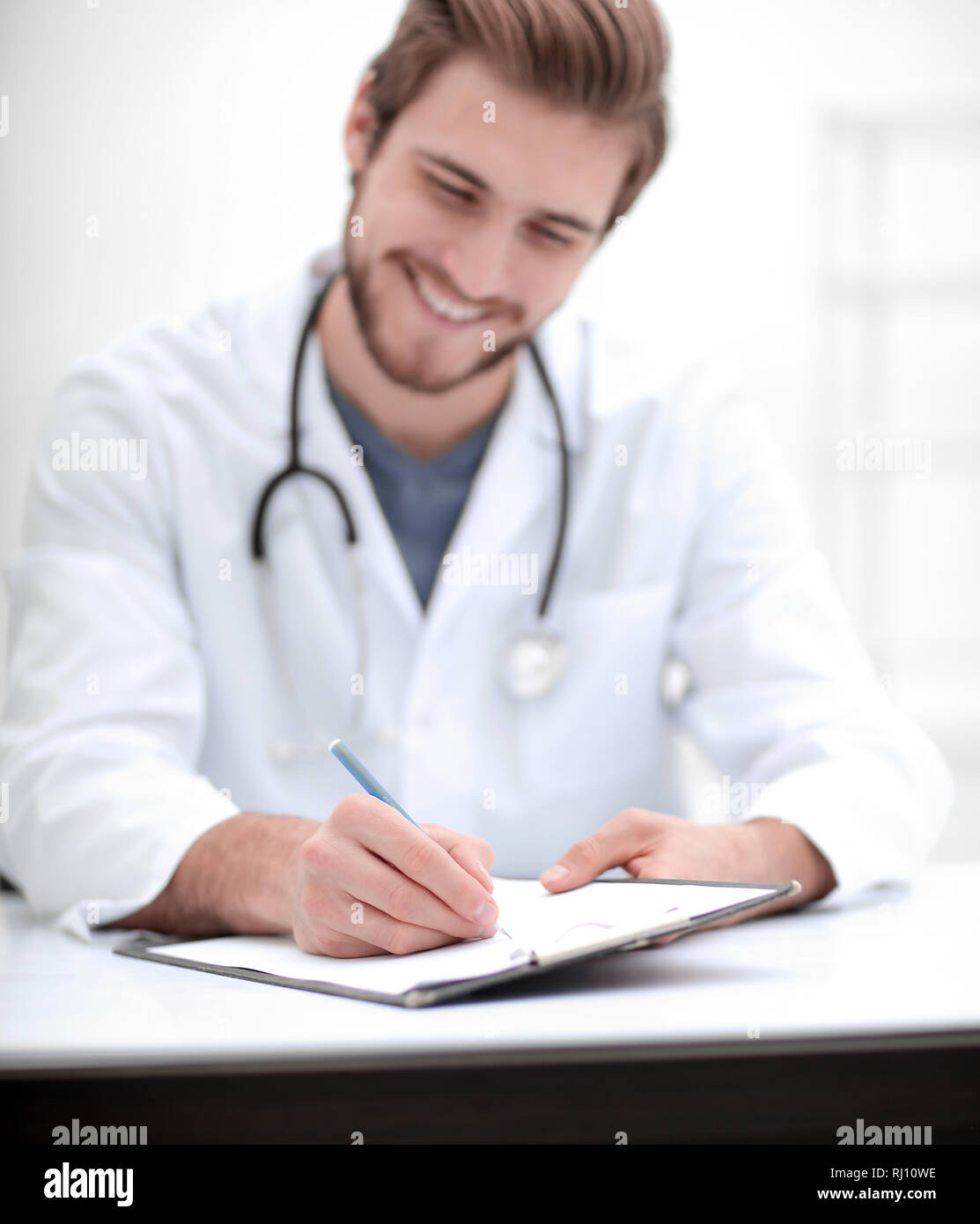 background image of a doctor writing out a prescription Stock Photo - Alamy