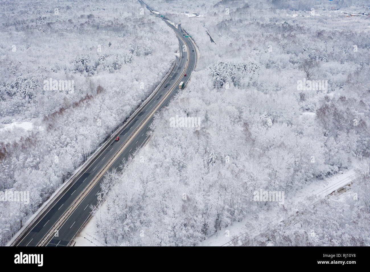 Aerial view of winter beautiful landscape road with trees covered with ...