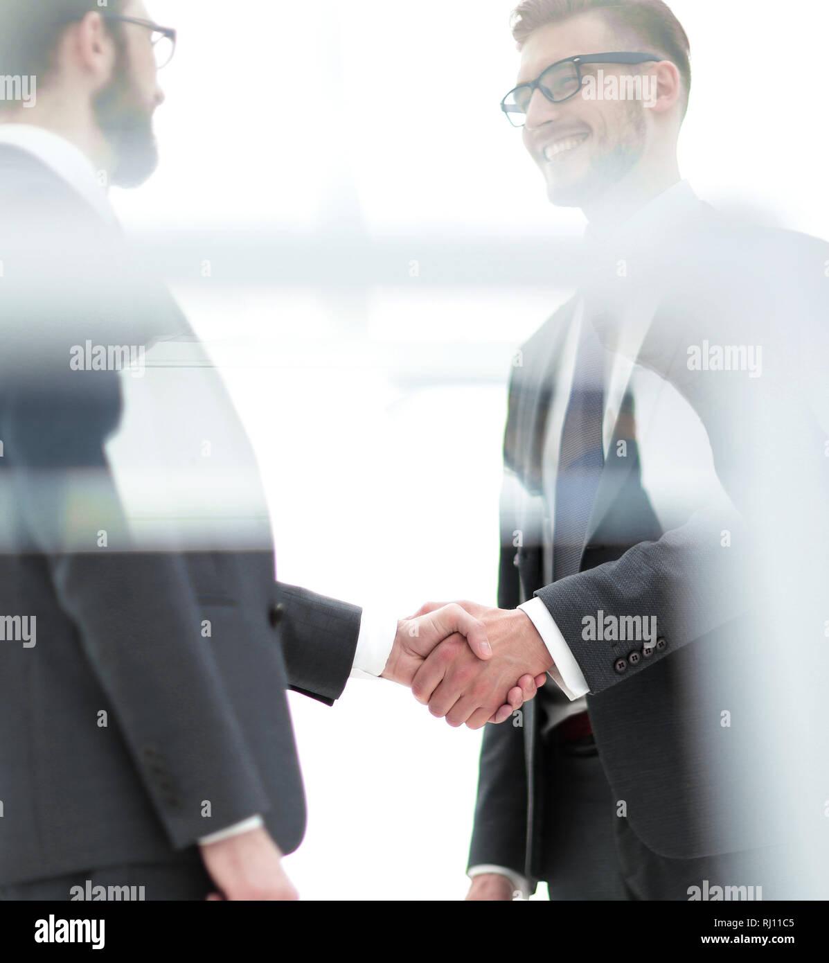 handshake is serious business partners Stock Photo - Alamy