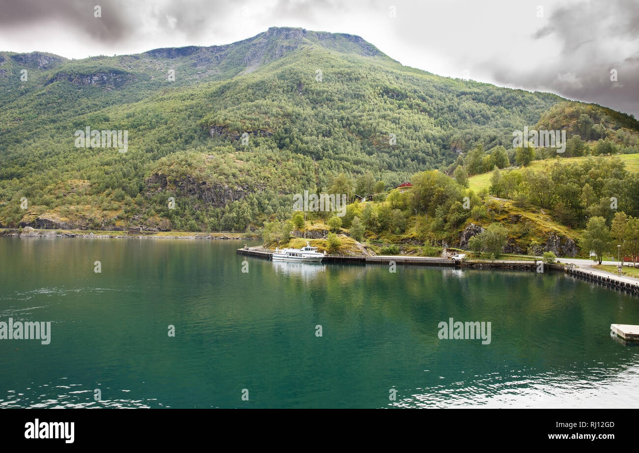 Landscape with Naeroyfjord, ship, mountains, traditional houses and ...