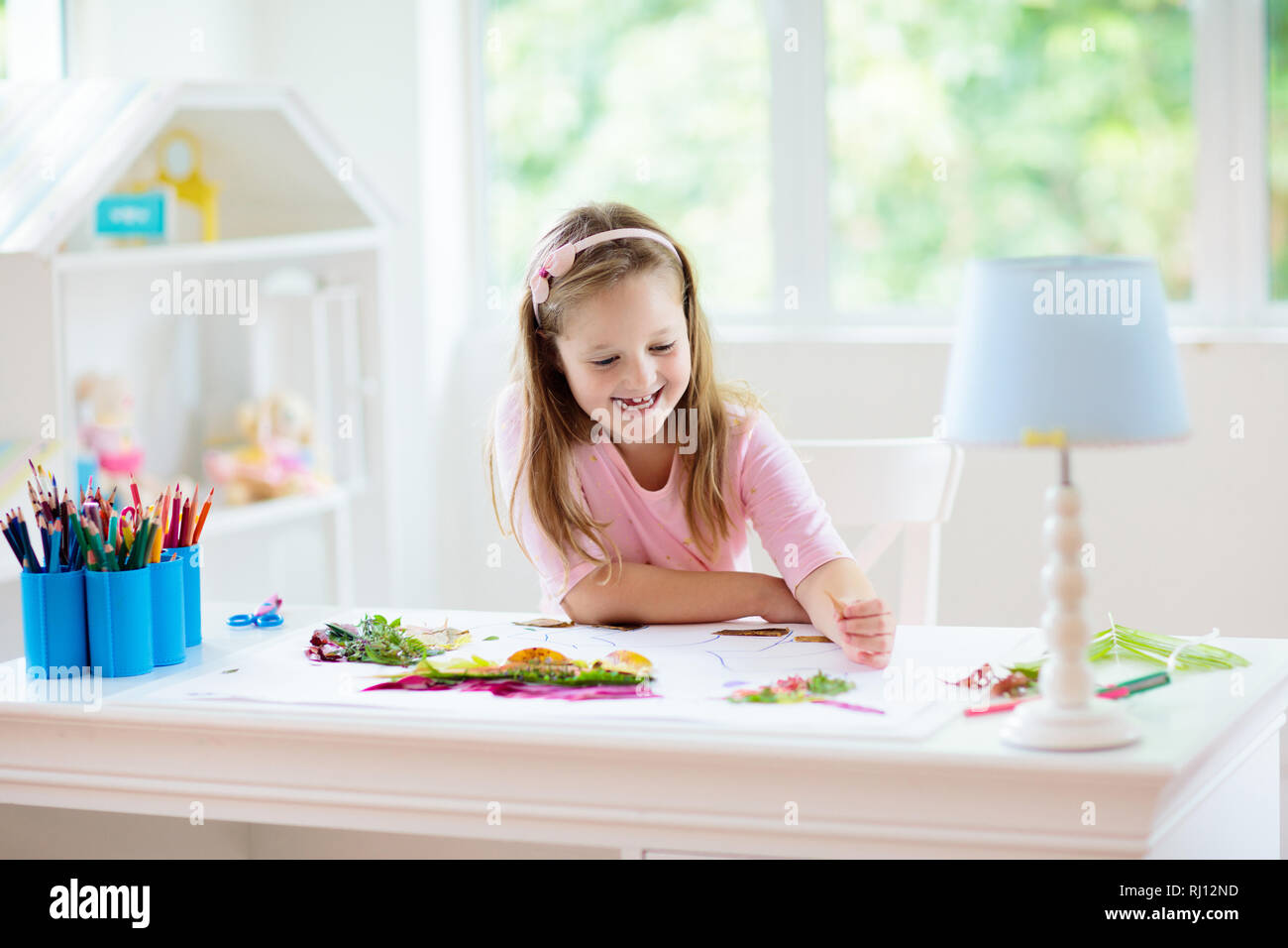 Child drawing rainbow. Kid painting at home. Little girl doing homework ...