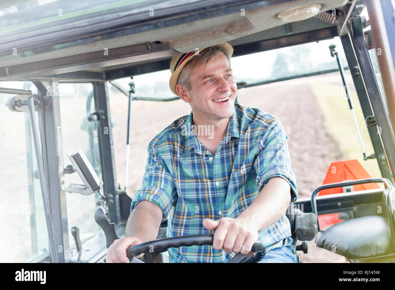 Farmer driving tractor hi-res stock photography and images - Alamy